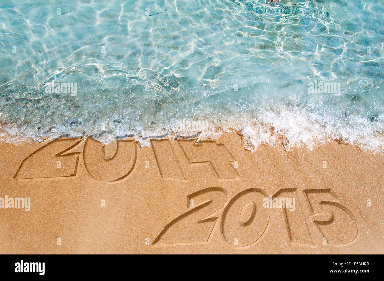 New Year word sign on the beach sand Stock Photo - Alamy