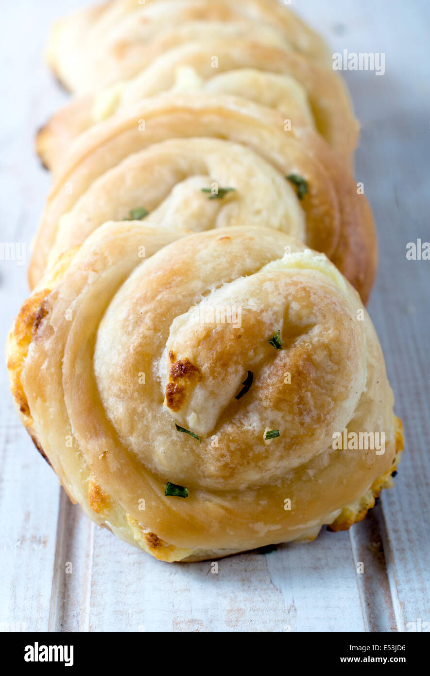 Golden and fresh baked mini cheese pies on the wooden background ...