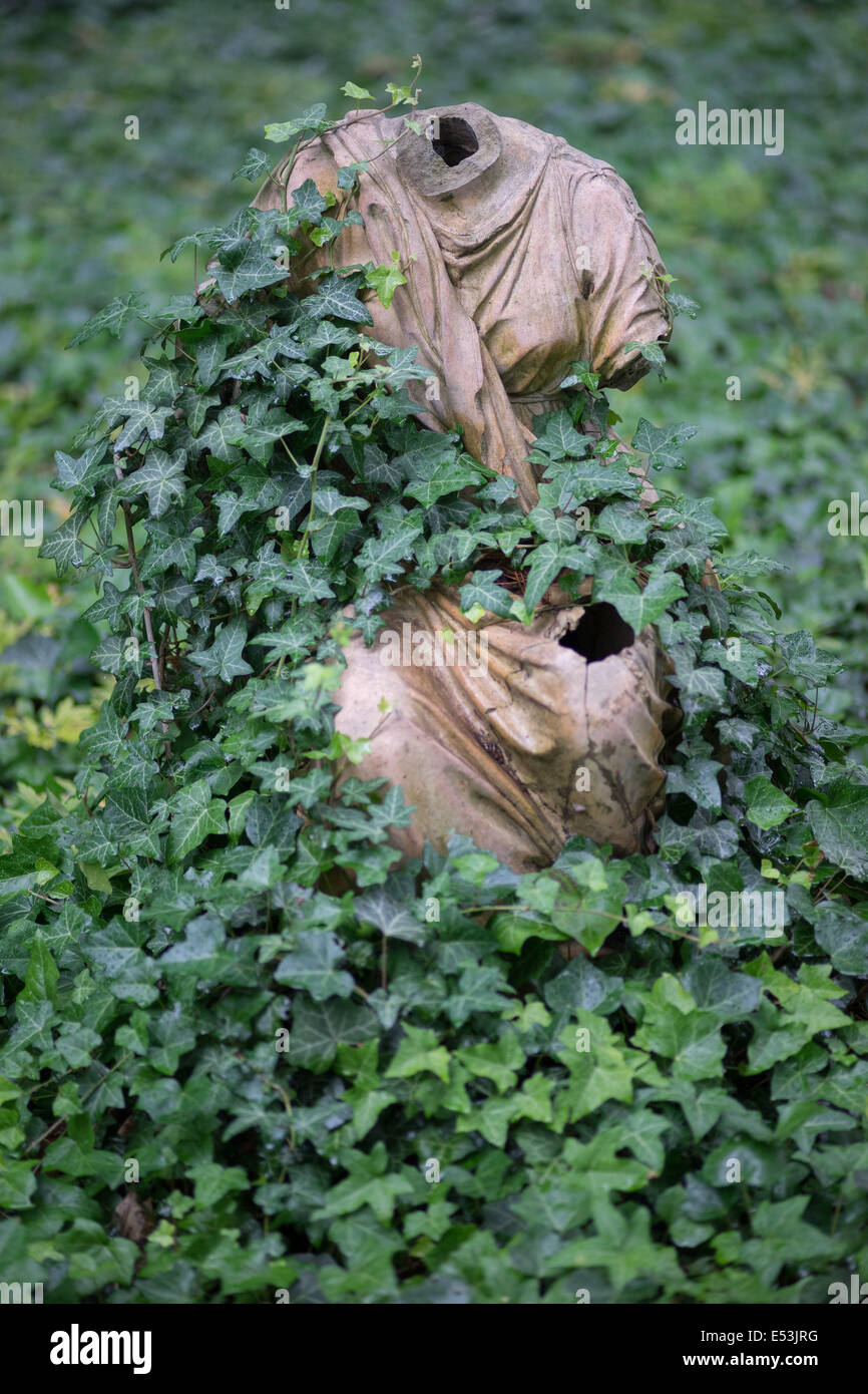 Headless body sculpture covered with ivy Stock Photo - Alamy