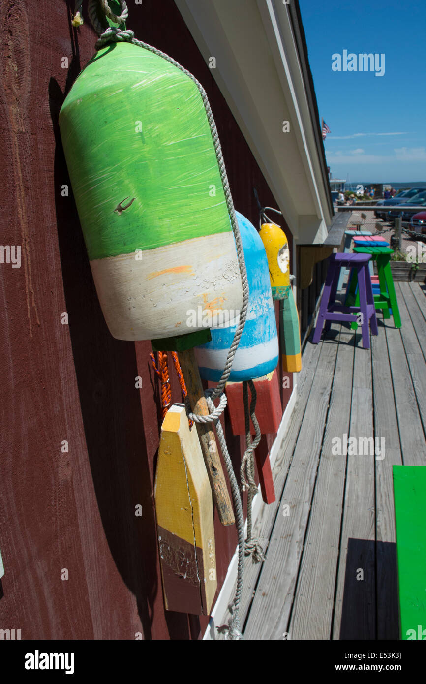 Maine, Bar Harbor. Colorful lobster trap buoys hanging on wall Stock ...