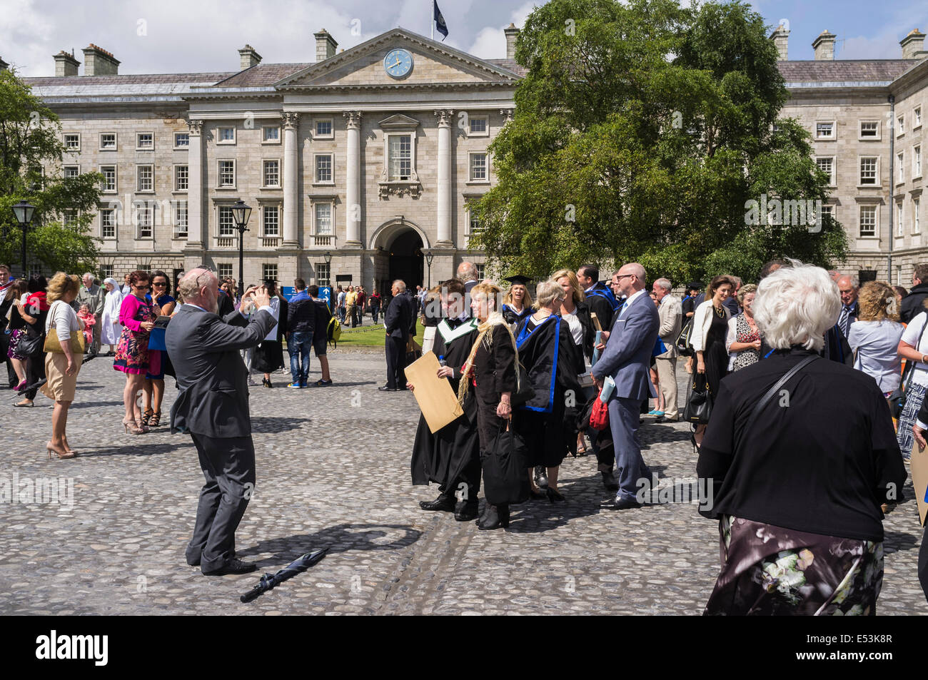 Students on graduation day in the main square in cap and gowns ...
