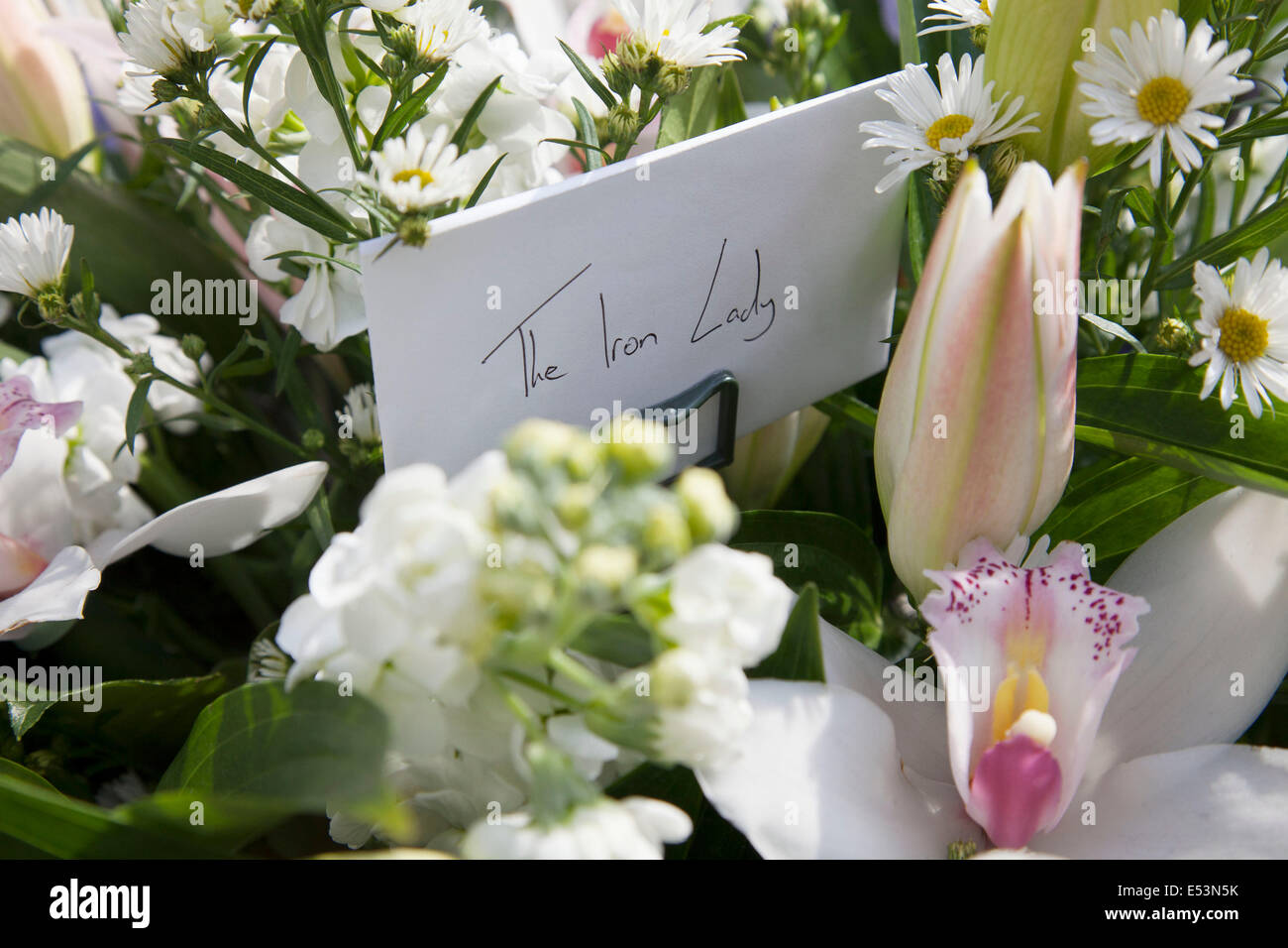 London, UK. Monday 8th April 2013. Flowers and messages gather at the ...