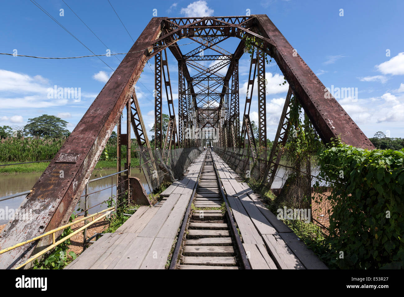 An elevated former railroad grade and rickety bridge connects Guabito ...