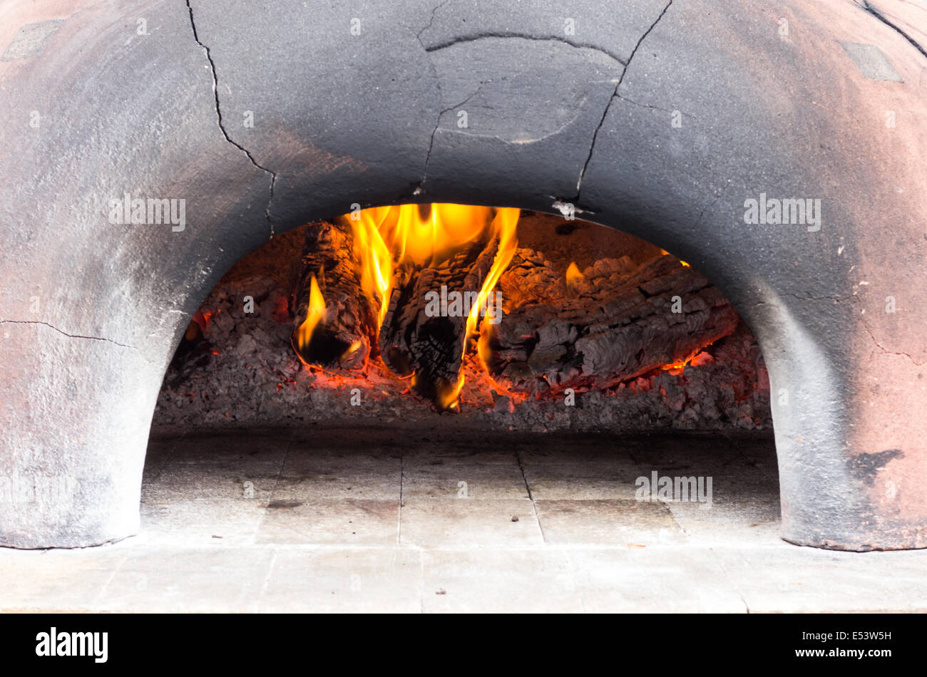 Wood fired oven for bread or pizza with fire Stock Photo - Alamy