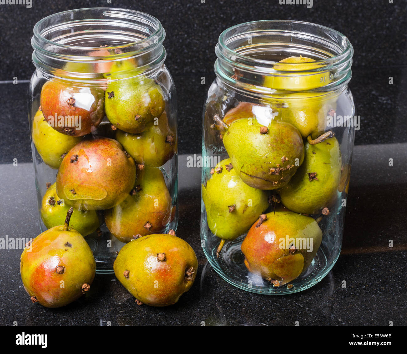 Spiced Seckel pears with cloves being preserved Stock Photo - Alamy