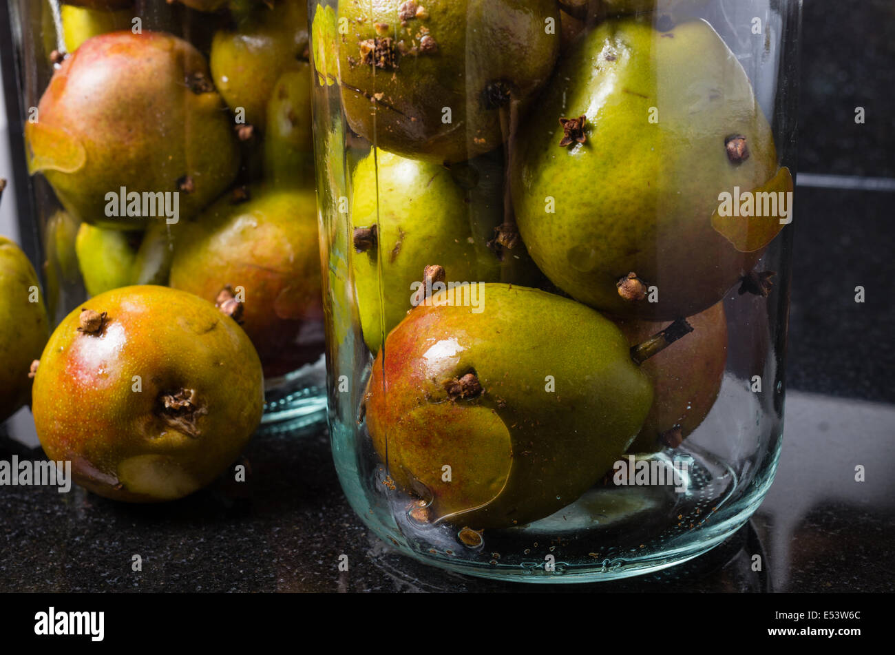 Spiced Seckel pears with cloves being preserved Stock Photo - Alamy
