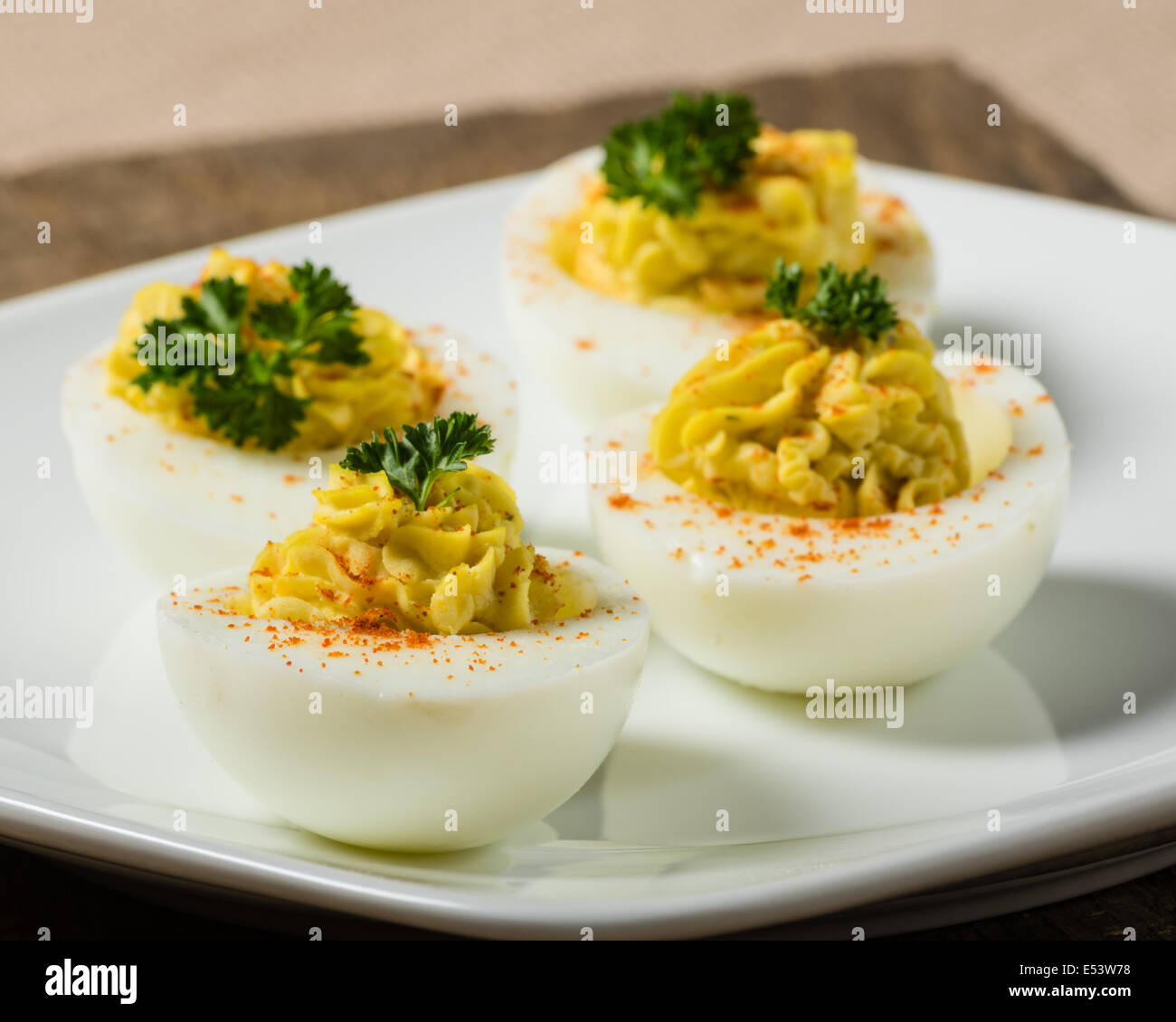 Piped and filled deviled eggs garnished with parsley and paprika Stock ...