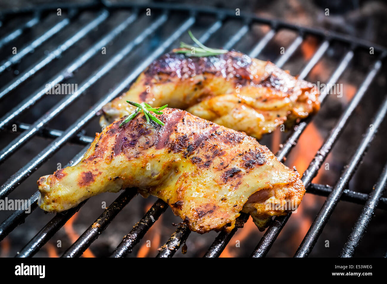 Roasted chicken legs on the grill with fire Stock Photo - Alamy