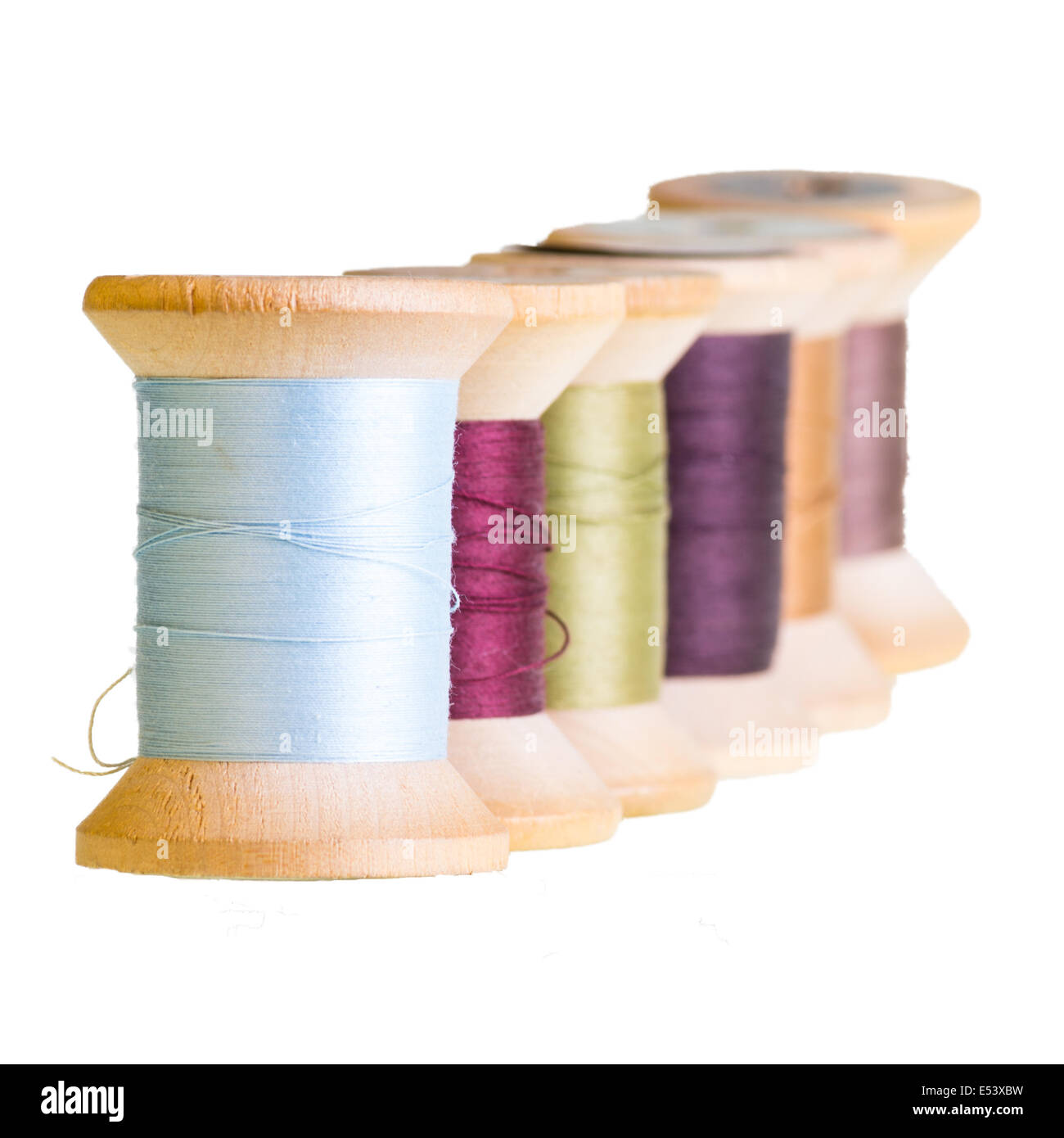 Row of wooden sewing thread spools Stock Photo - Alamy