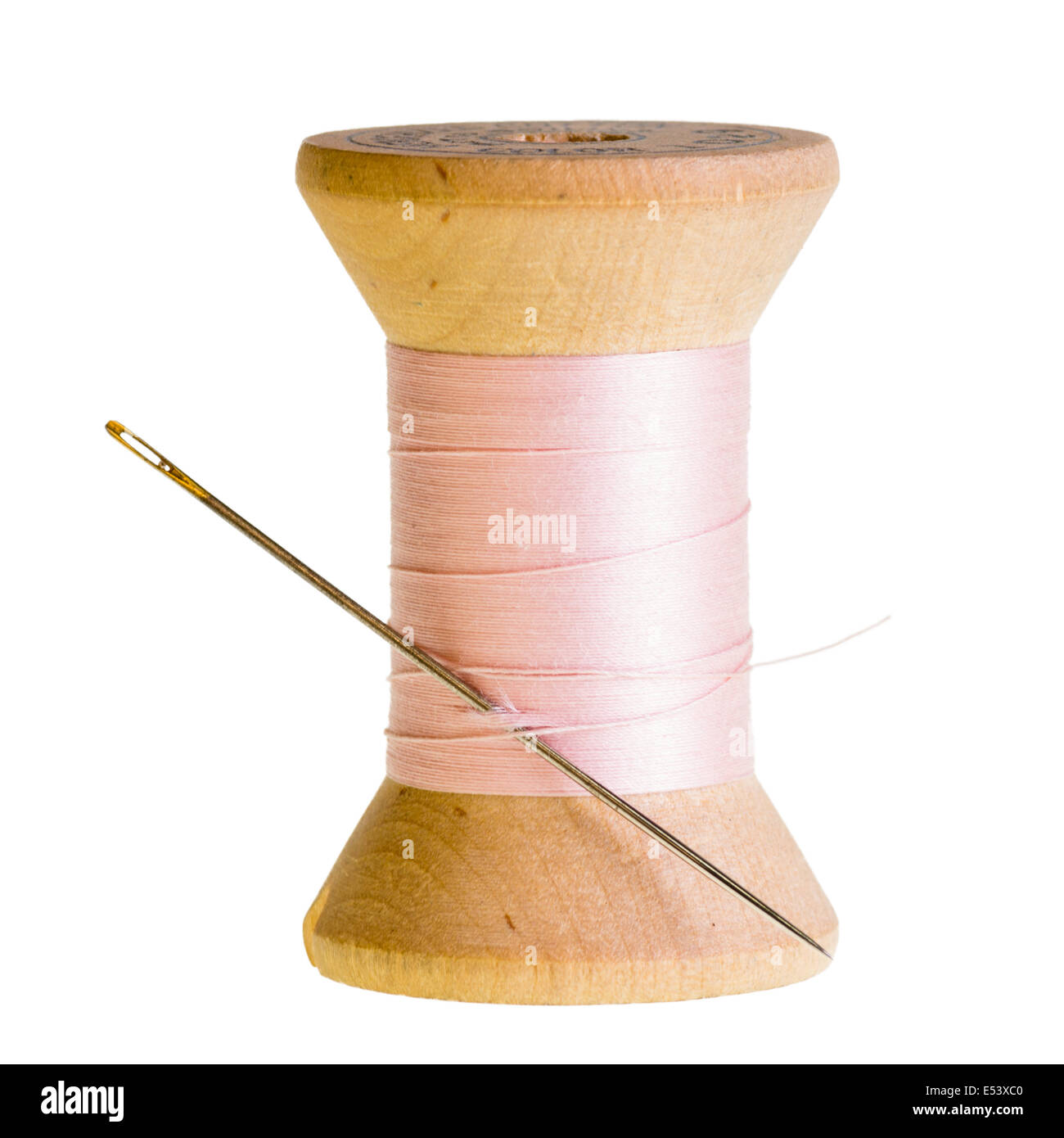 Spool of pink thread with a needle isolated on white Stock Photo - Alamy