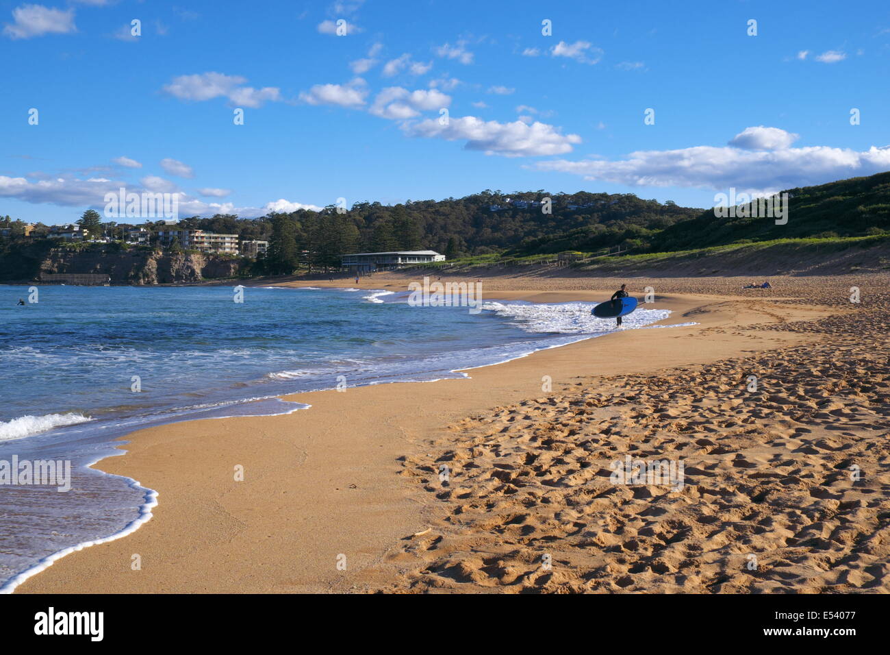 Surfer stood on the sand, winters day on avalon beach, which is one of ...