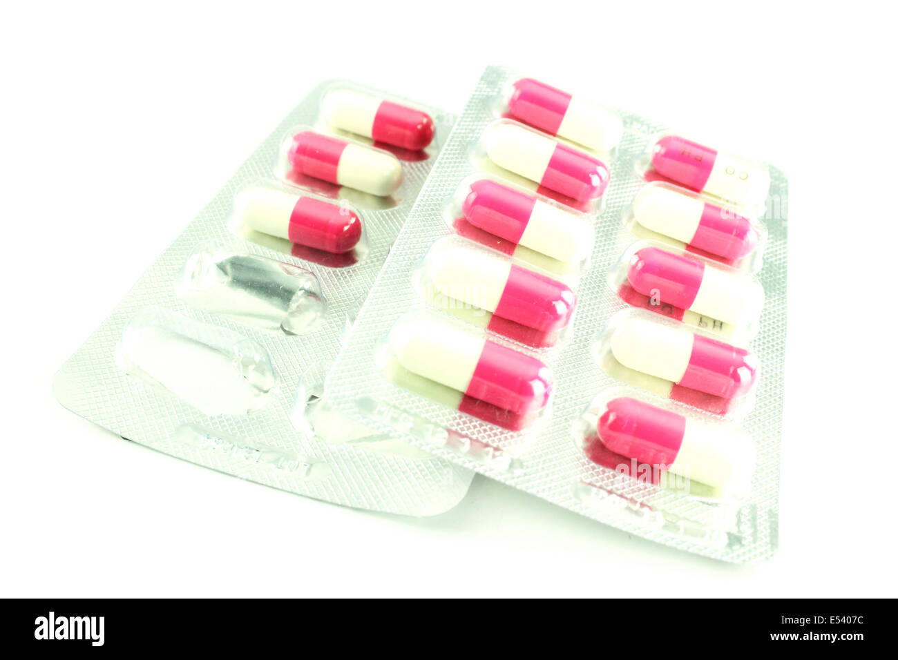 Pink and white medicine on a white background Stock Photo - Alamy