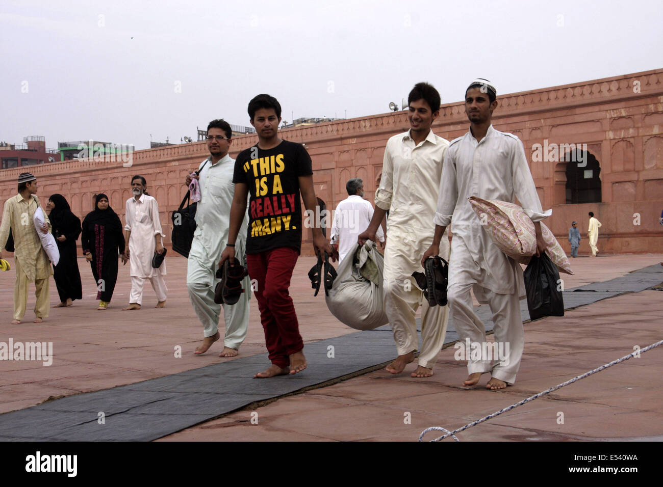 Lahore. 19th July, 2014. Pakistani Muslims carry their belongings as ...