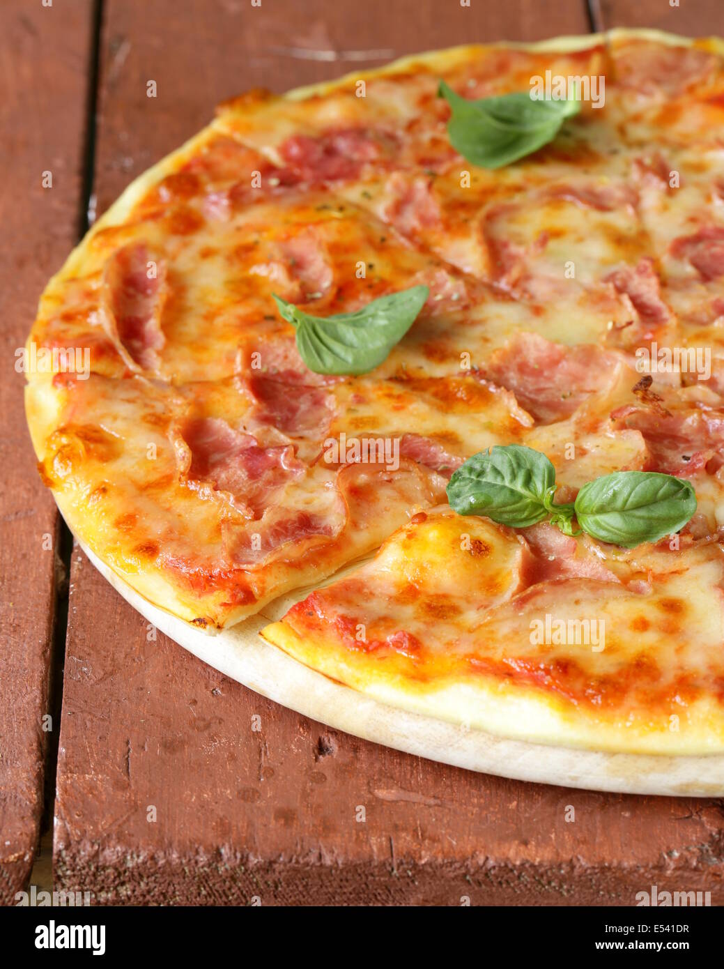 traditional Italian pizza with prosciutto ham and basil Stock Photo - Alamy