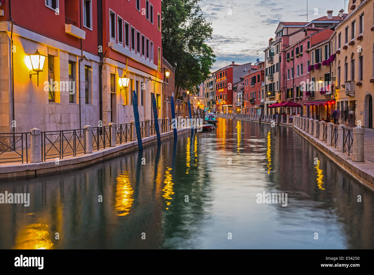 Narrow canal among old colorful brick houses in Venice, Italy Stock ...