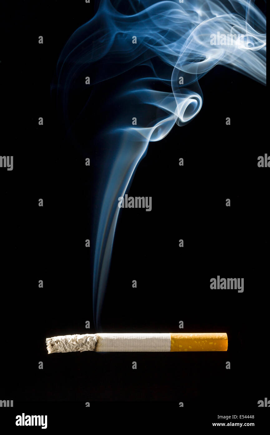 Rising smoke from filter tipped cigarette hi-res stock photography and ...