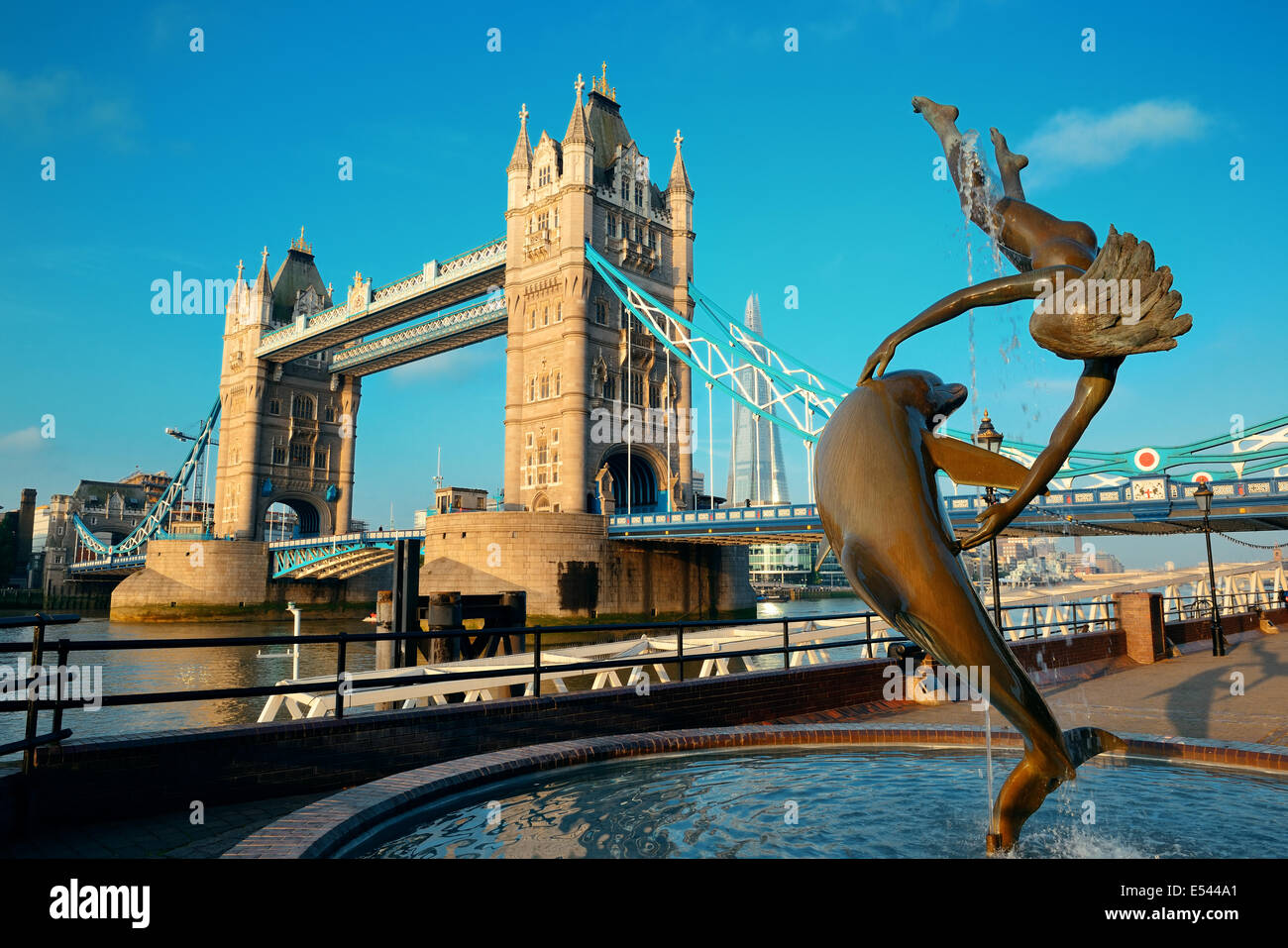 Tower Bridge and girl, dolphin statue over Thames River in London Stock ...