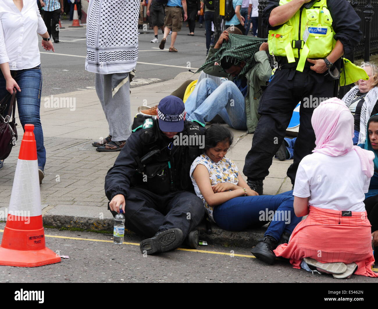 Metropolitan Police London Medic giving aid to demonstrator Police ...
