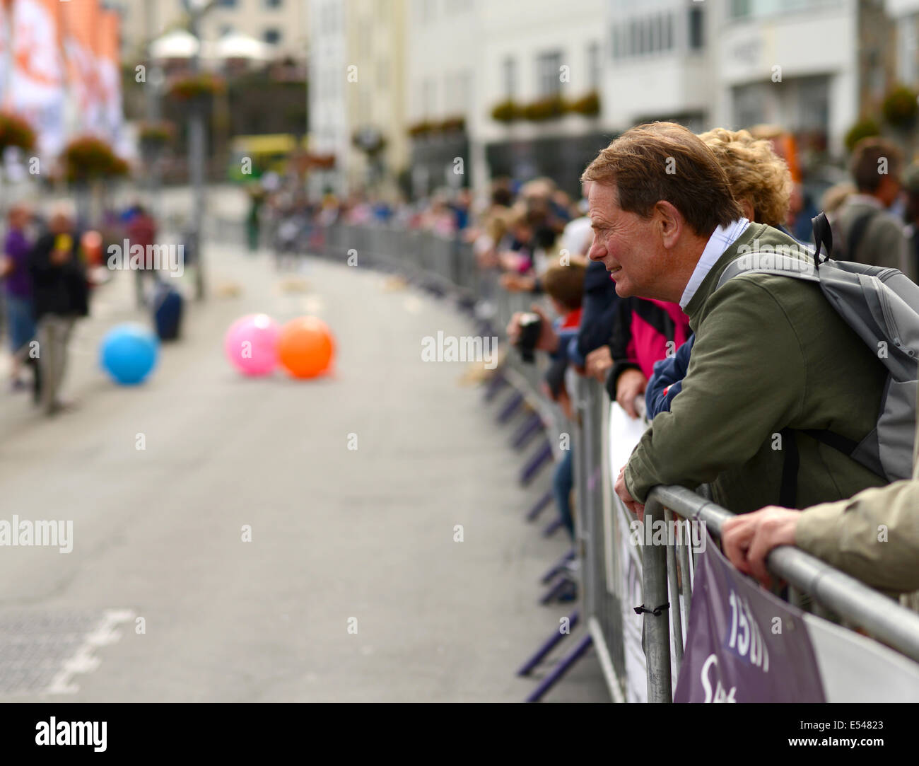 Man in crowd watching an event Stock Photo - Alamy