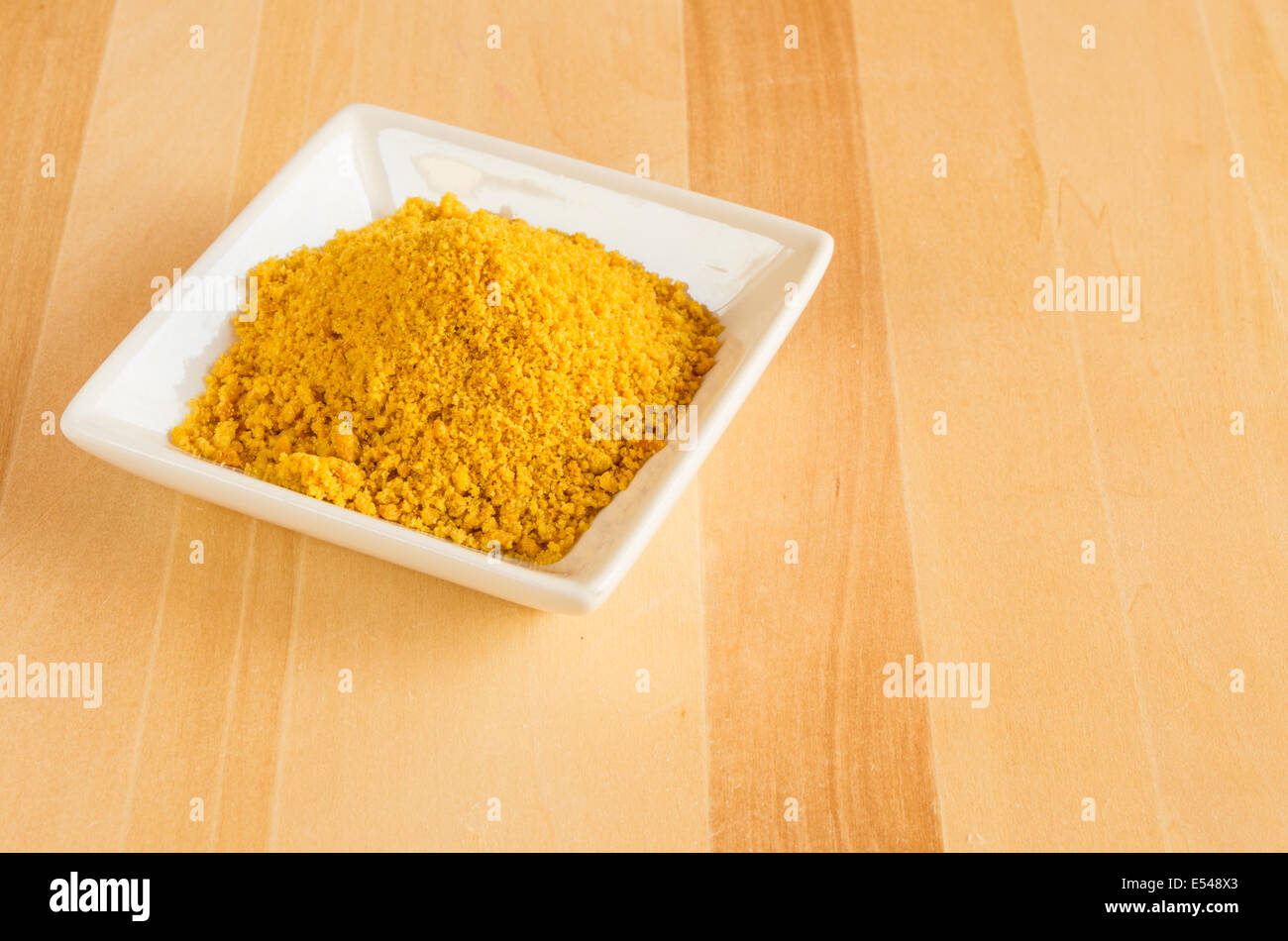 A white plate of tumeric spice for use in cooking Stock Photo - Alamy