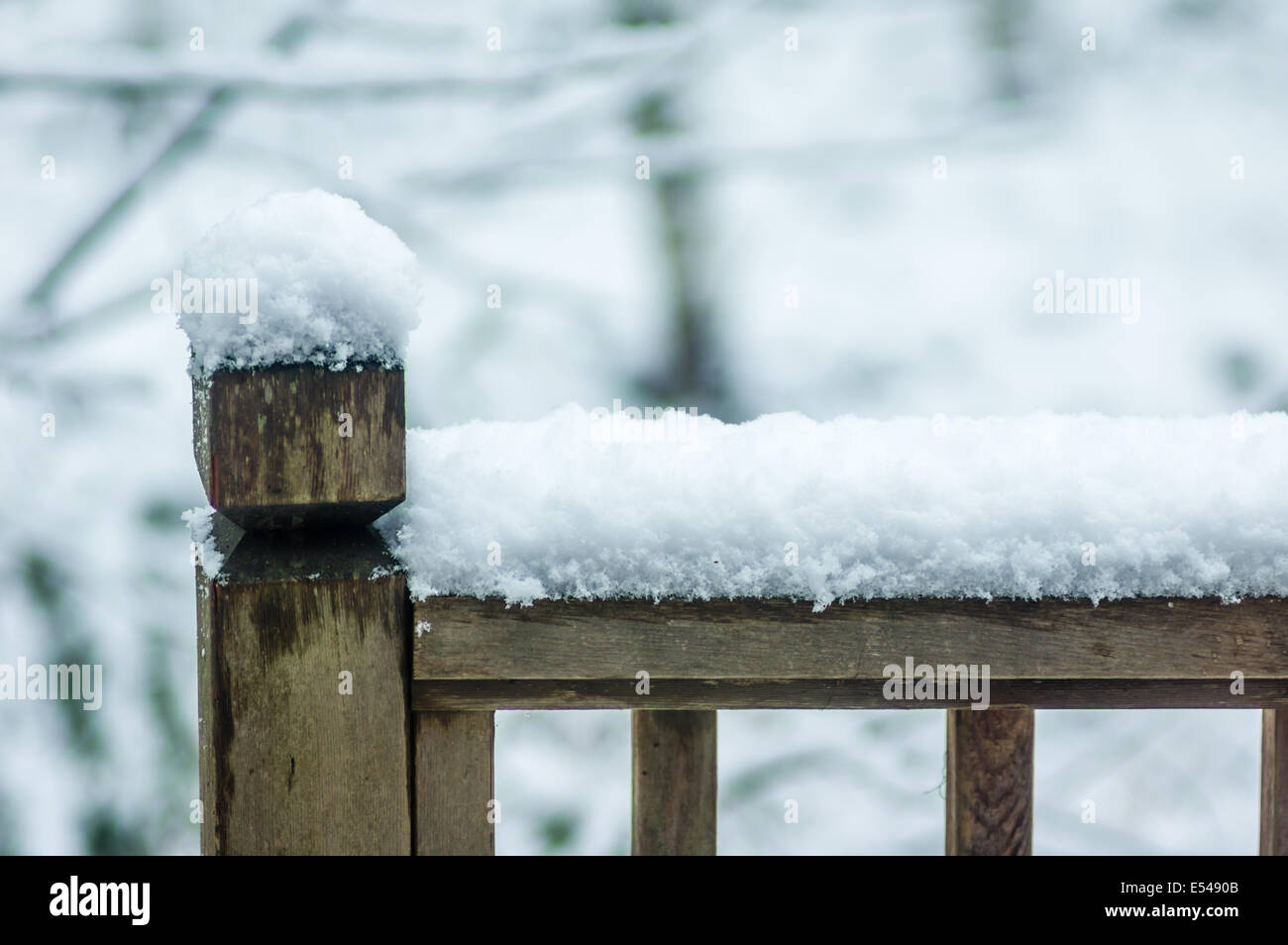 Snow covered fence railing in winter storm Stock Photo - Alamy