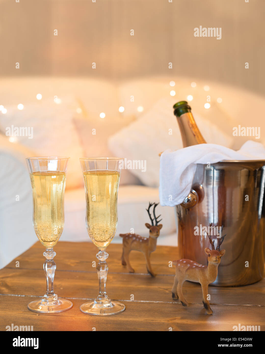 Two glasses of champagne with ice bucket and reindeer Stock Photo - Alamy