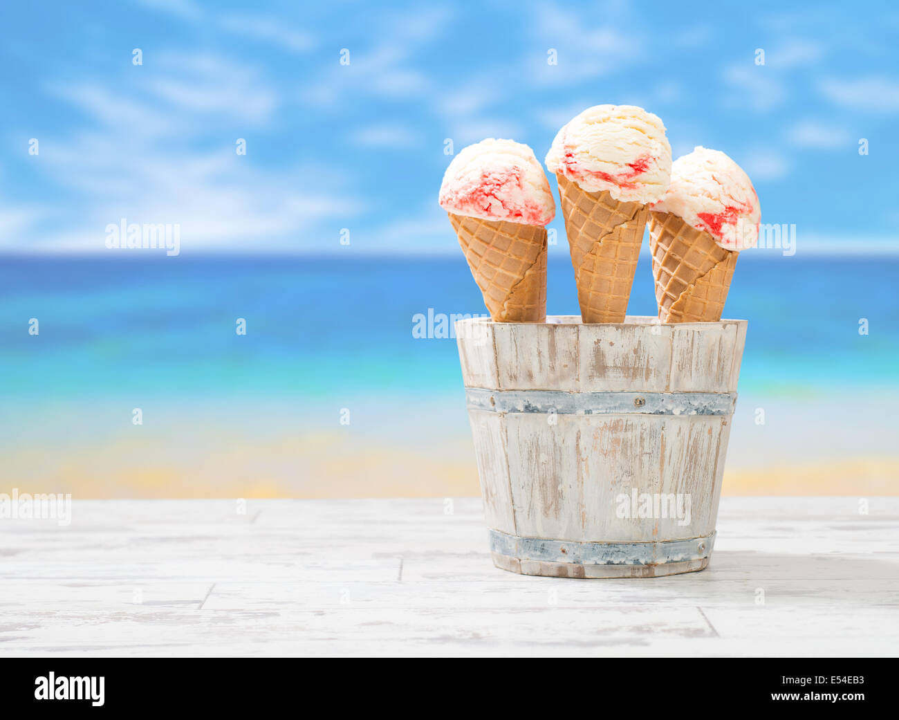 Raspberry ripple ice creams with beach blur background Stock Photo - Alamy