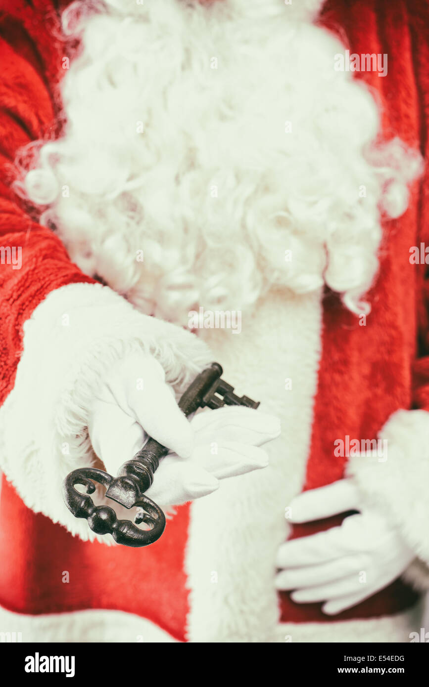 Santa Claus holding the key to Christmas Stock Photo - Alamy