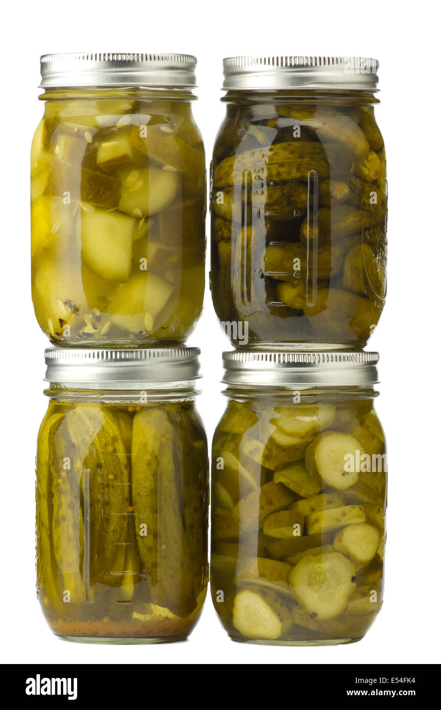 Four jars of assorted homemade pickles isolated Stock Photo - Alamy