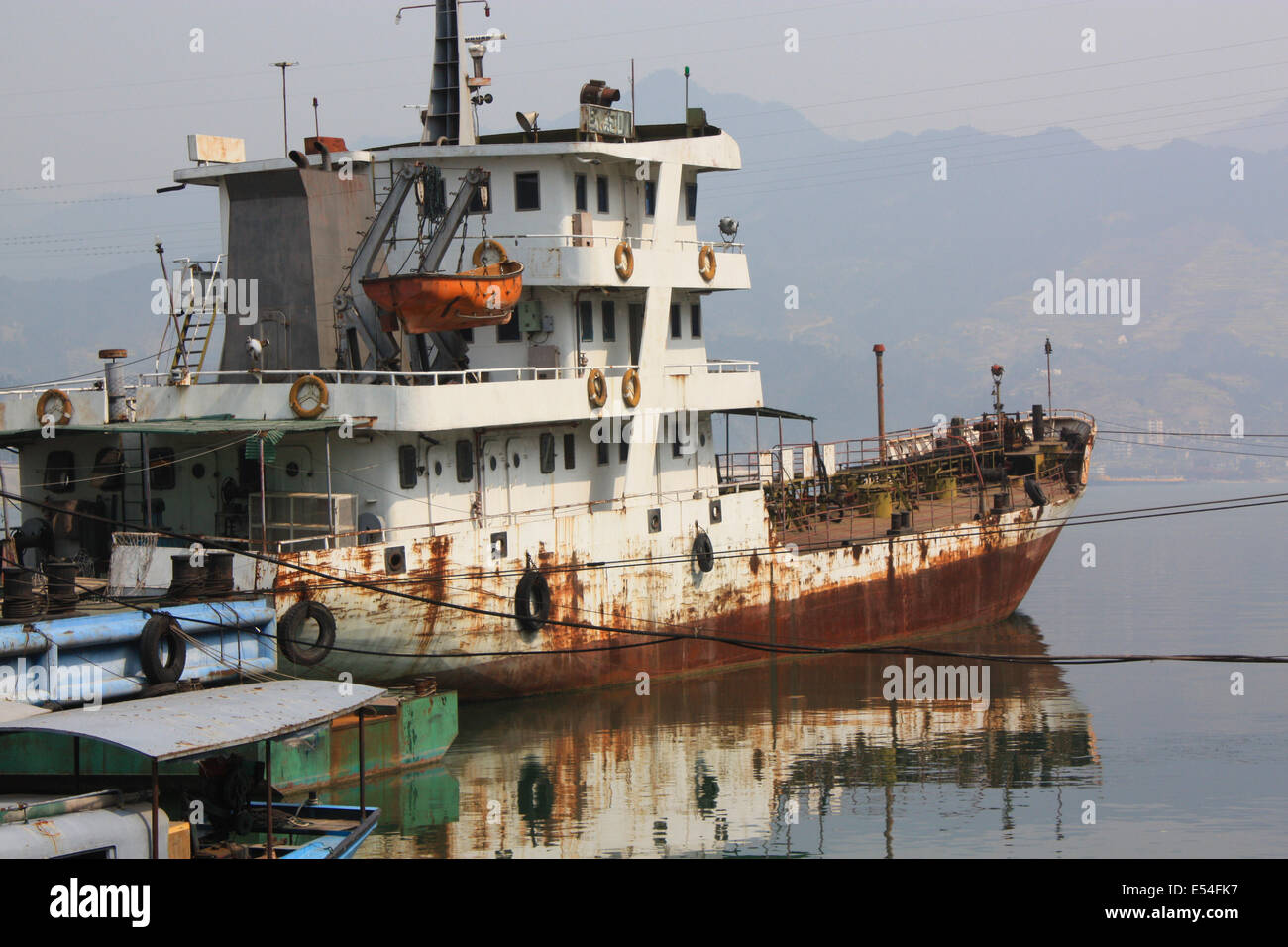 Old Rusting Ship on Calm Water Stock Photo - Alamy
