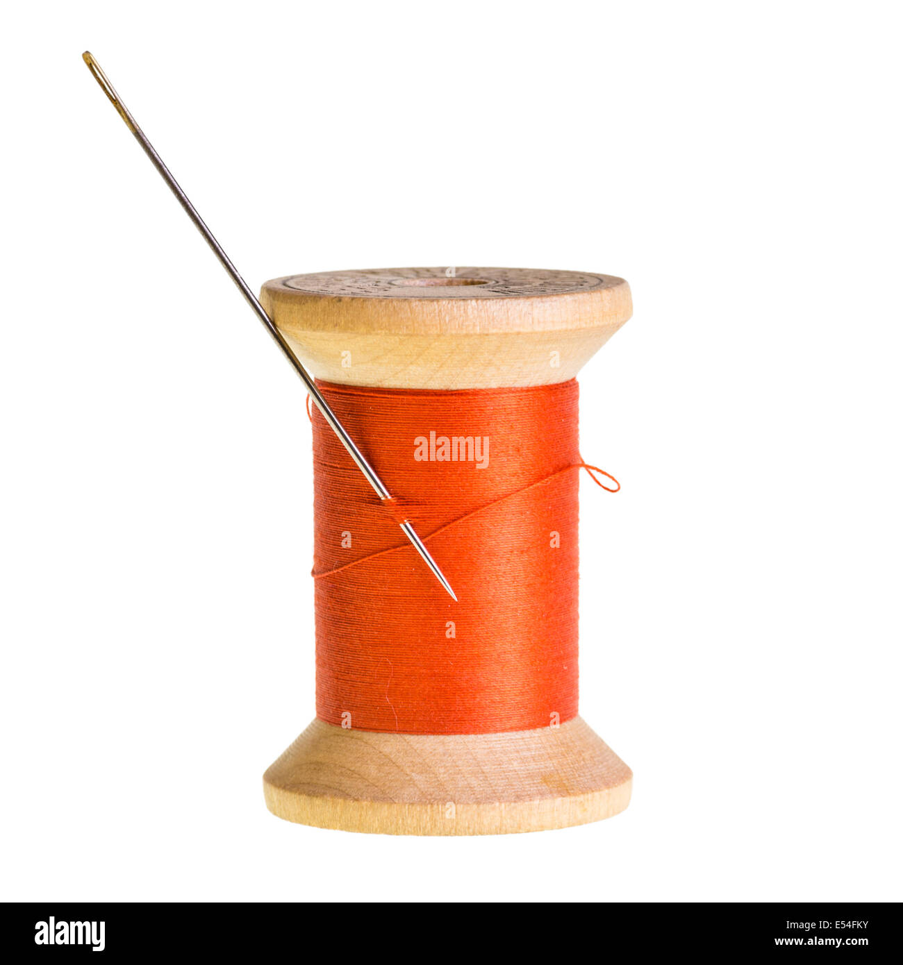 Spool of orange thread with a needle isolated Stock Photo - Alamy
