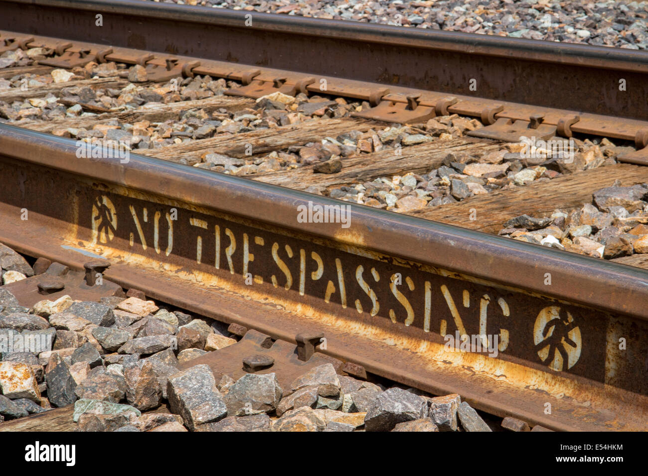 no trespassing sign painted on rusty railroad tracks Stock Photo - Alamy
