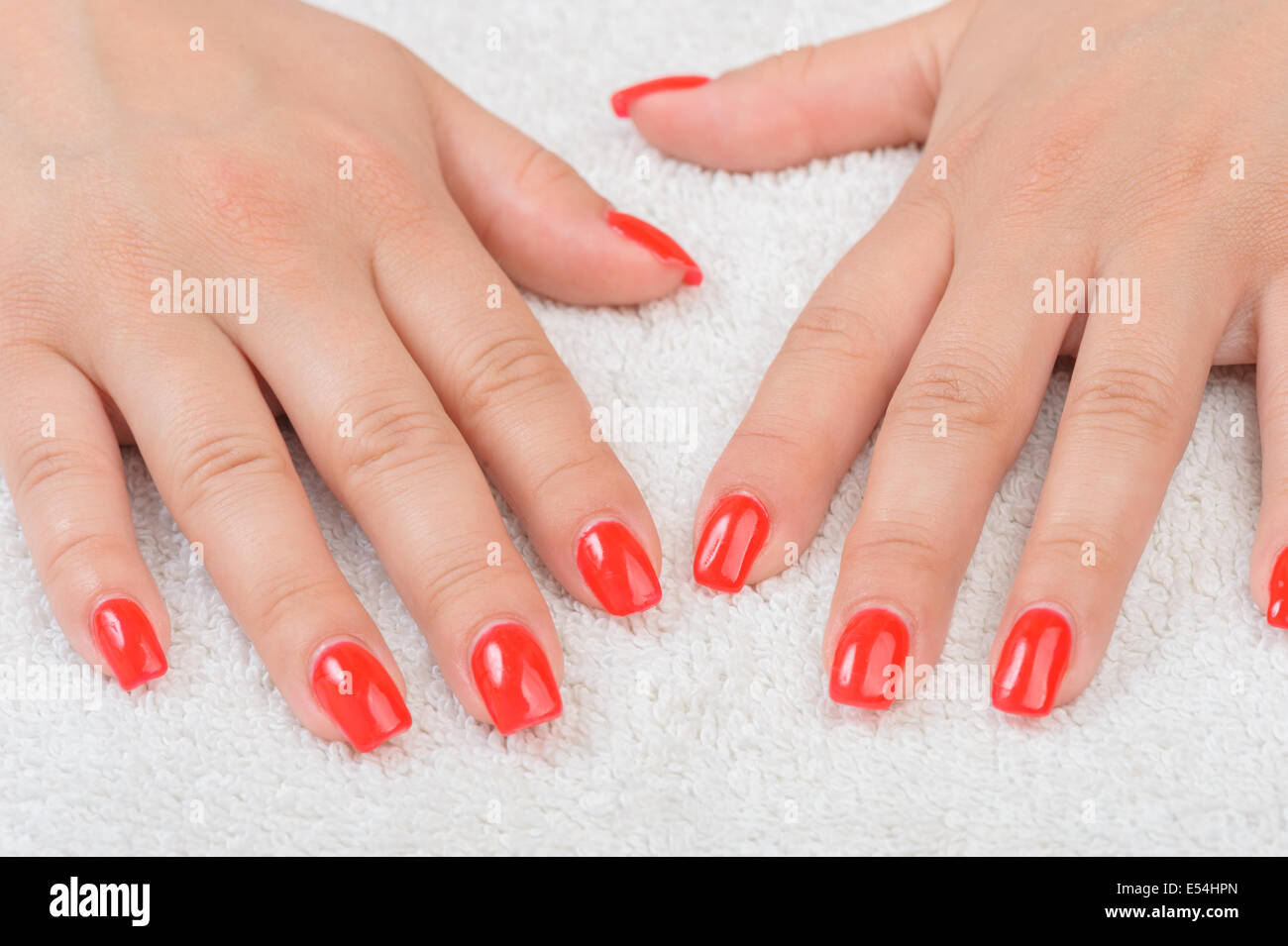 female fingers with red enamel Stock Photo - Alamy
