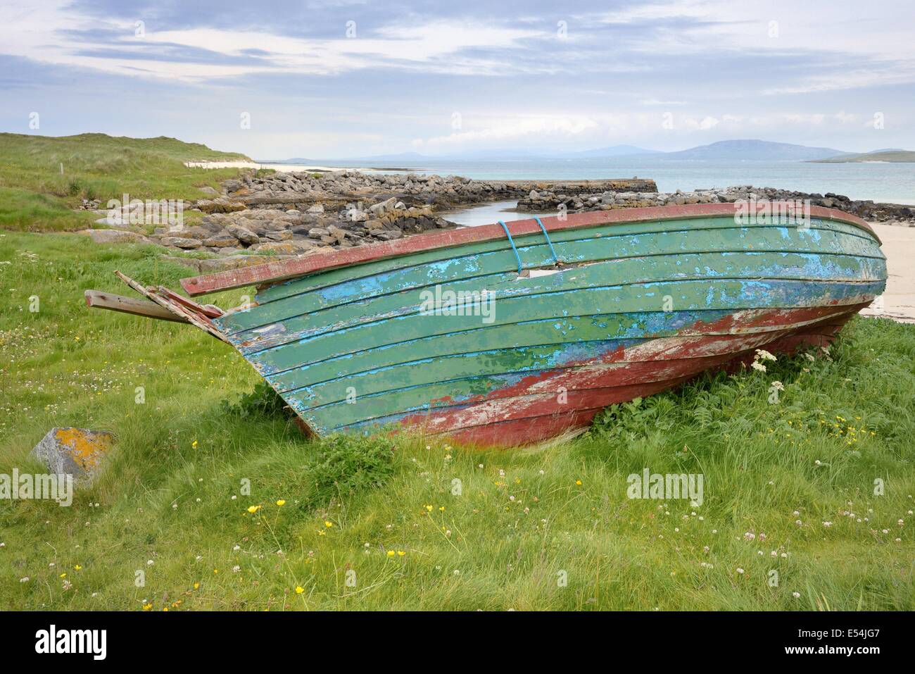 Small wrecked fishing boat lies abandoned on the grass near Eoligarry ...