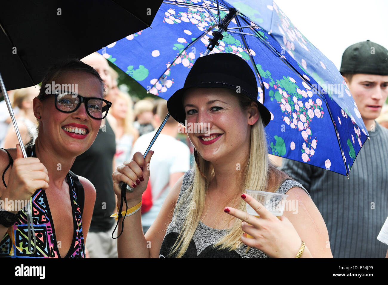 Freiburg, Germany. 20th July, 2014. Techno fans with an umbrella during ...
