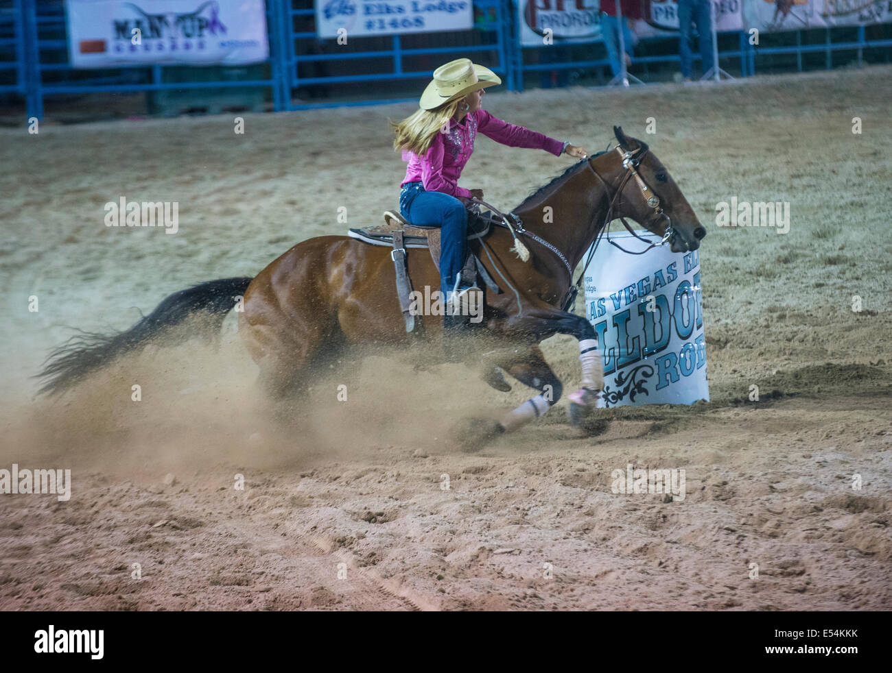 Cowgirl Participating in a Barrel racing competition at the Helldorado ...