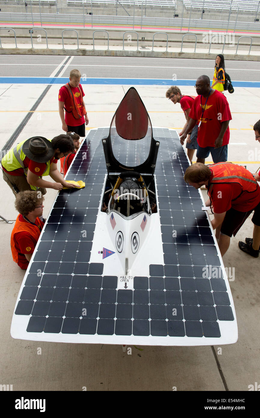 Students from Iowa State Univ. prep their solar car for a qualifying ...