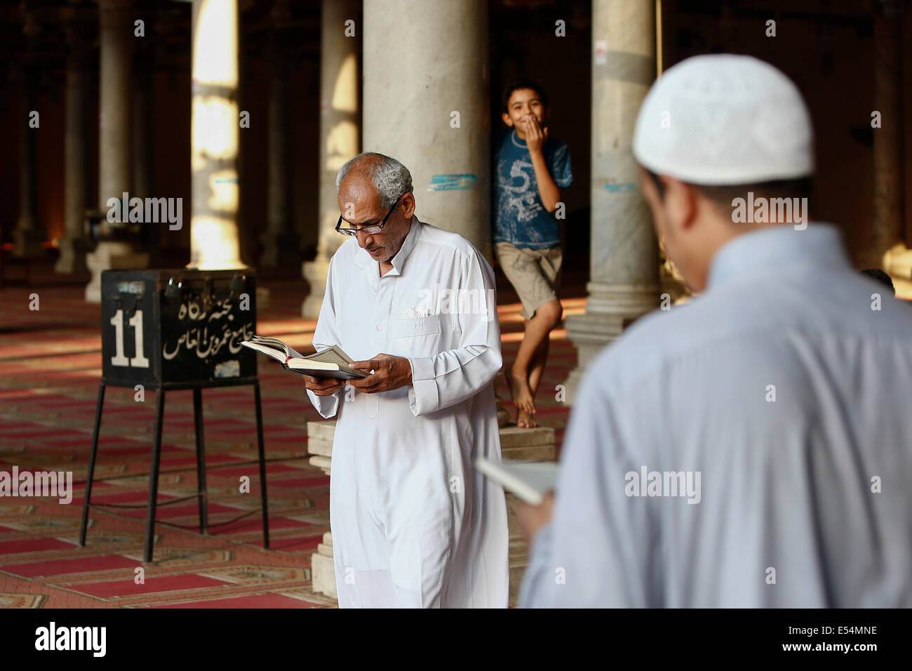 Cairo. 16th July, 2014. An Egyptian Muslim reads Quran in a mosque in ...
