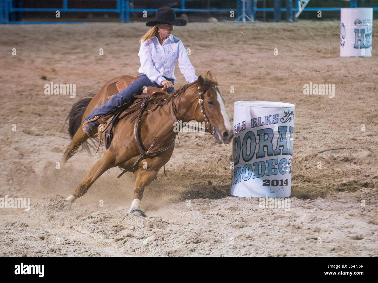 Cowgirl Participating in a Barrel racing competition at the Helldorado ...
