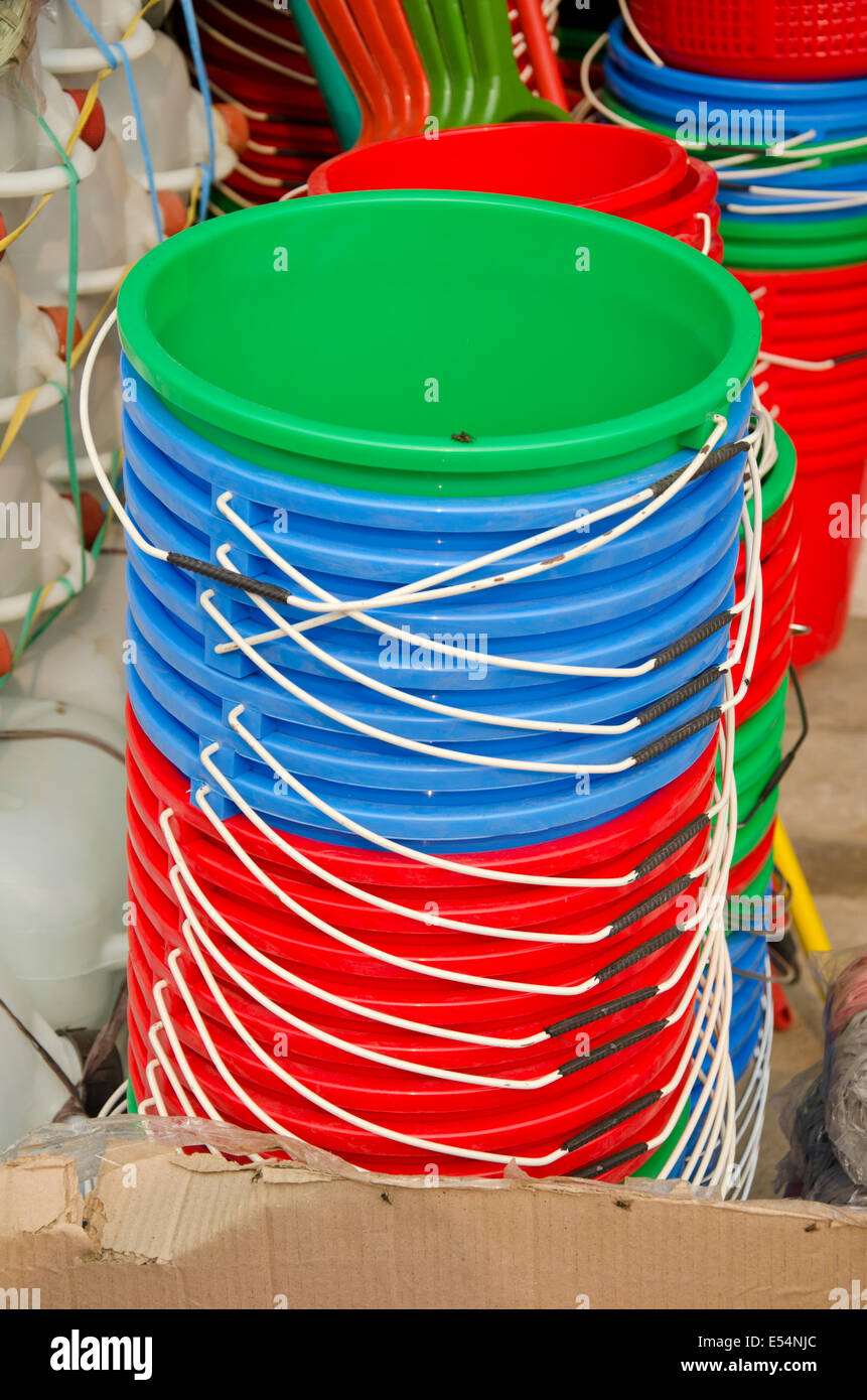 Colorful plastic buckets and other plasticware in asia market bazaar ...