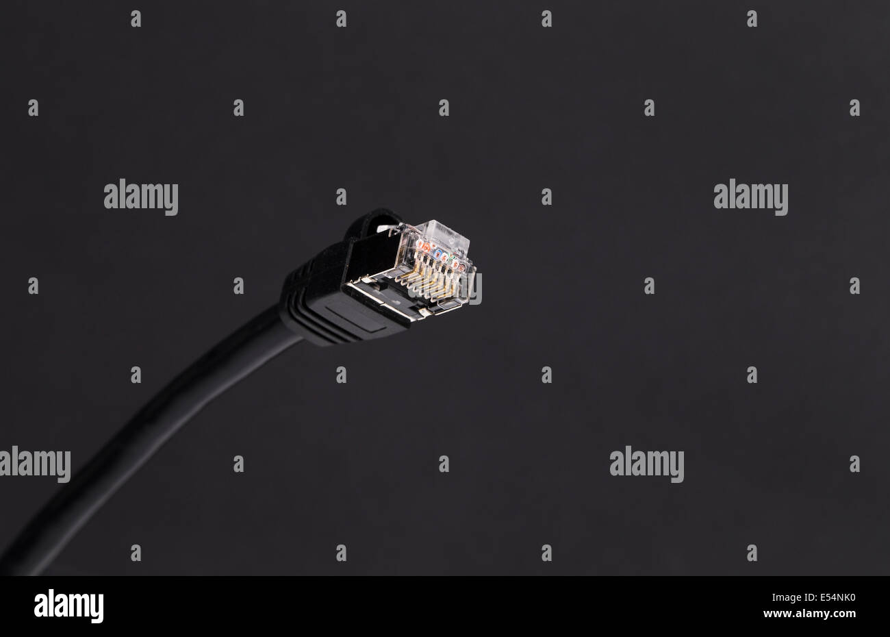 Image shows a black Network Cable on a dark background Stock Photo - Alamy