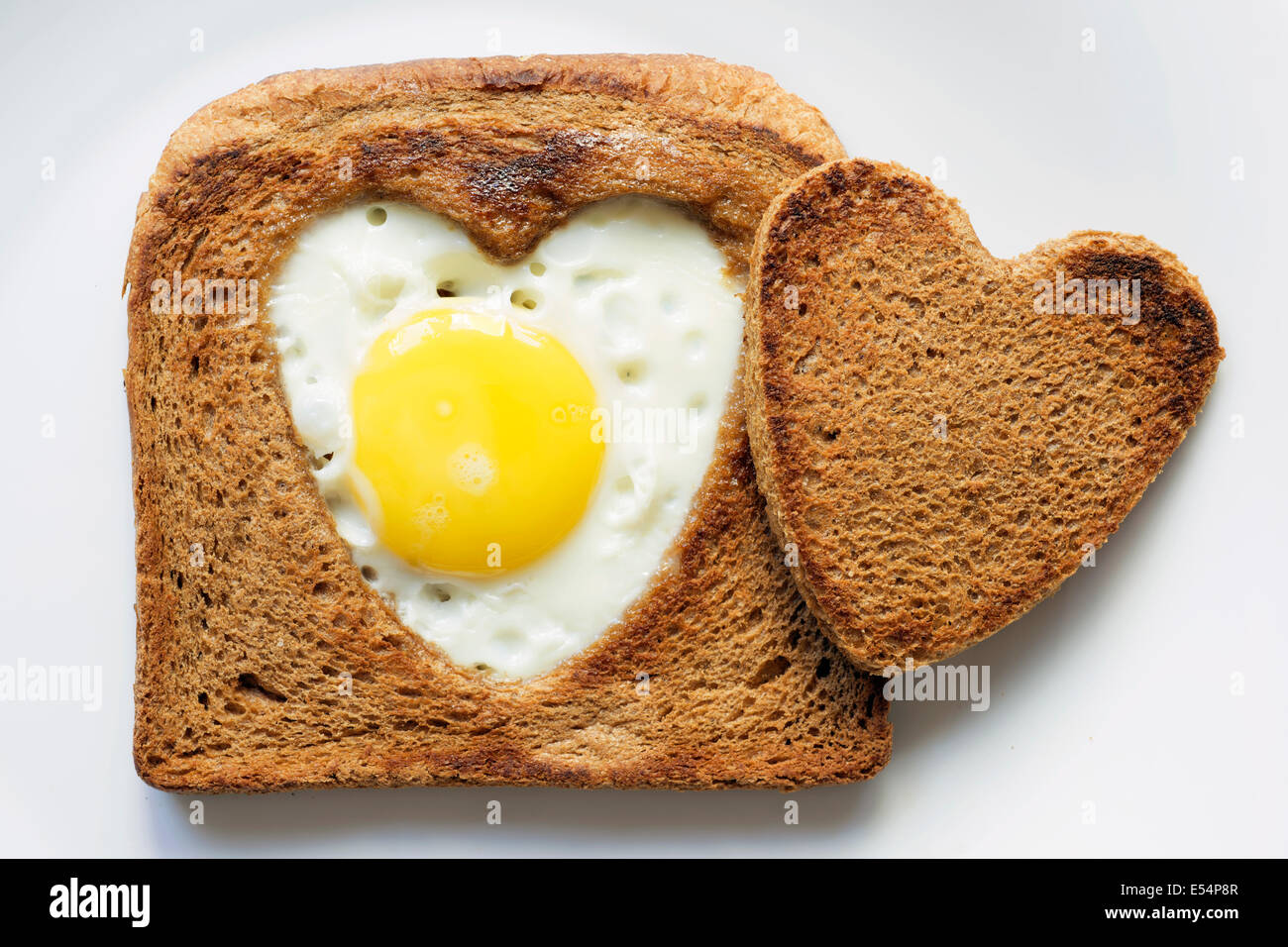 fried toast with egg inside in shape oh heart Stock Photo - Alamy
