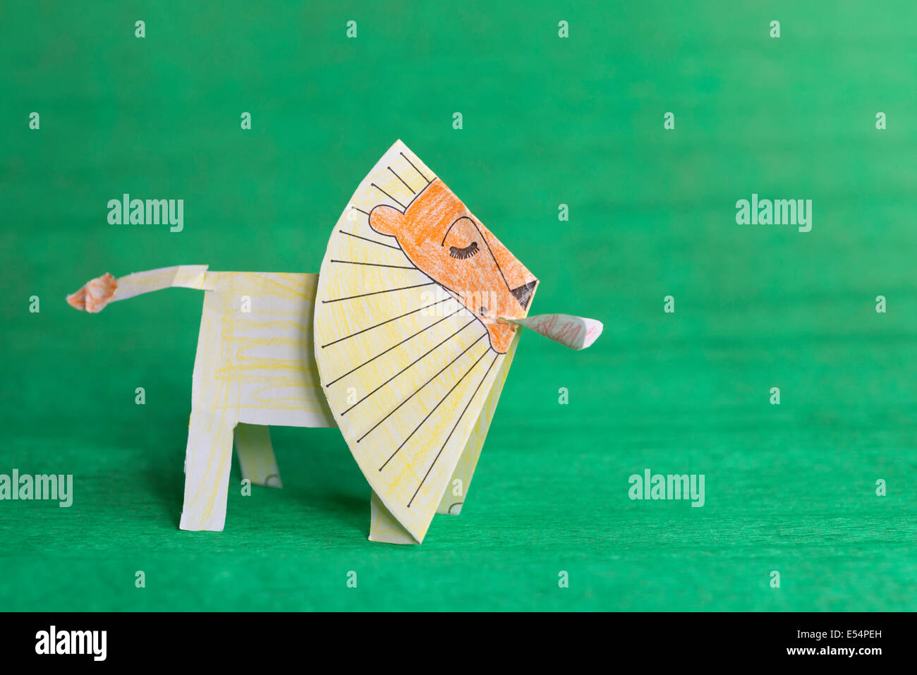 hand made paper lion on green background Stock Photo - Alamy