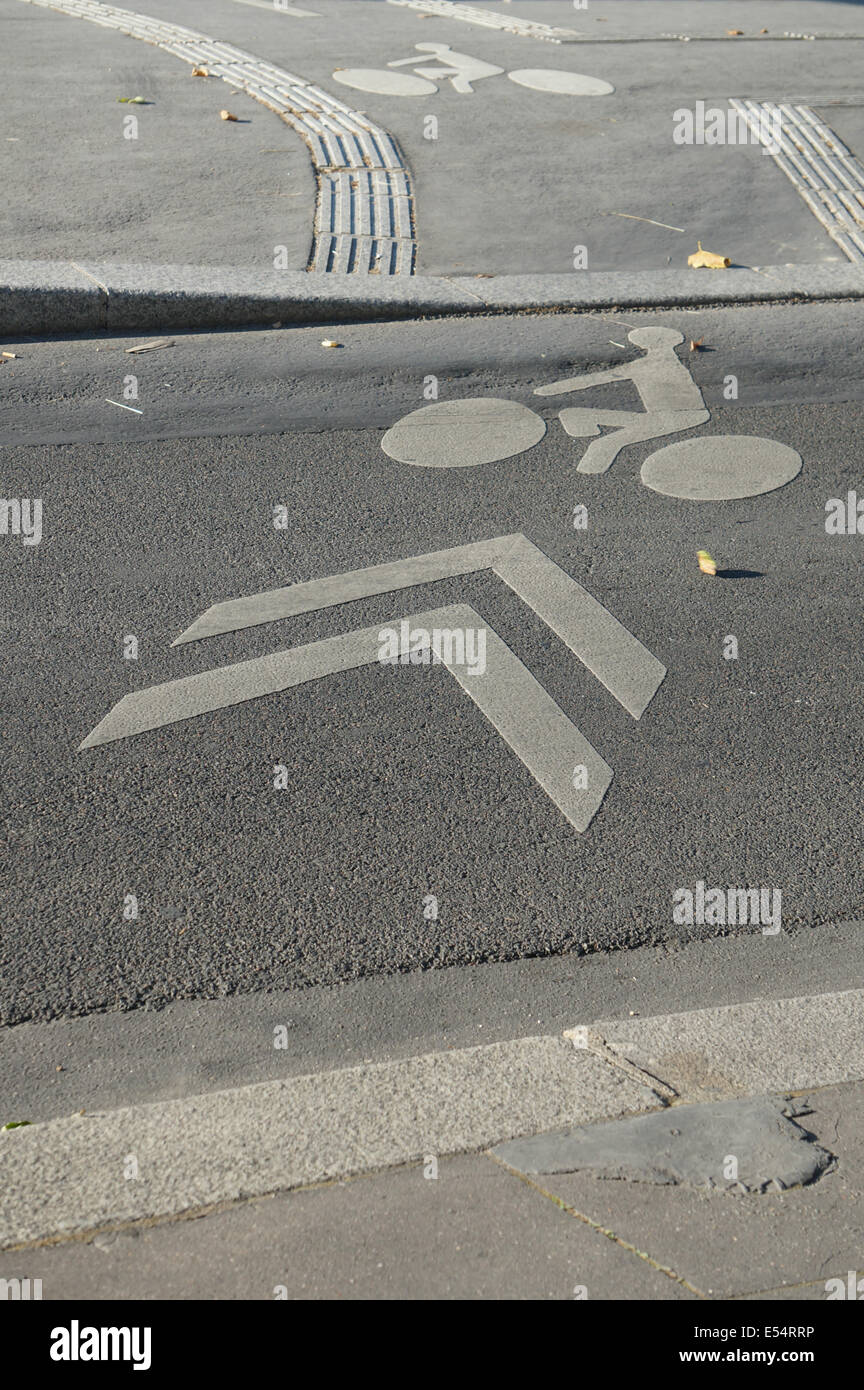Cycle path route across a junction in Paris marked by inset kerb stones ...