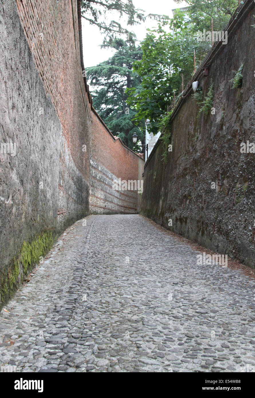 narrow cobblestone lane with bounded by walls of brick Stock Photo - Alamy