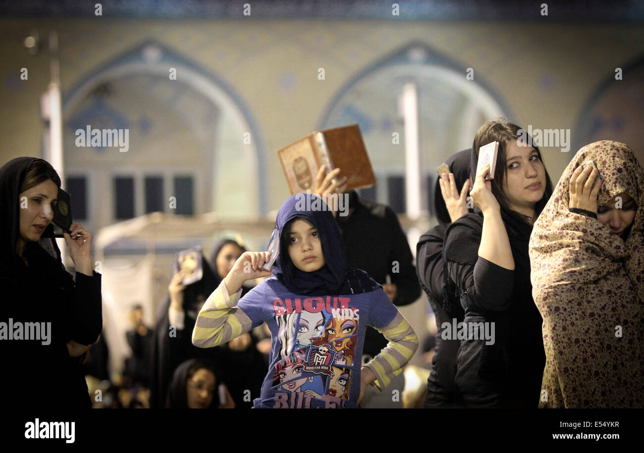 Tehran, Iran. 21st July, 2014. Iranian Shiite Muslims participate in a ...