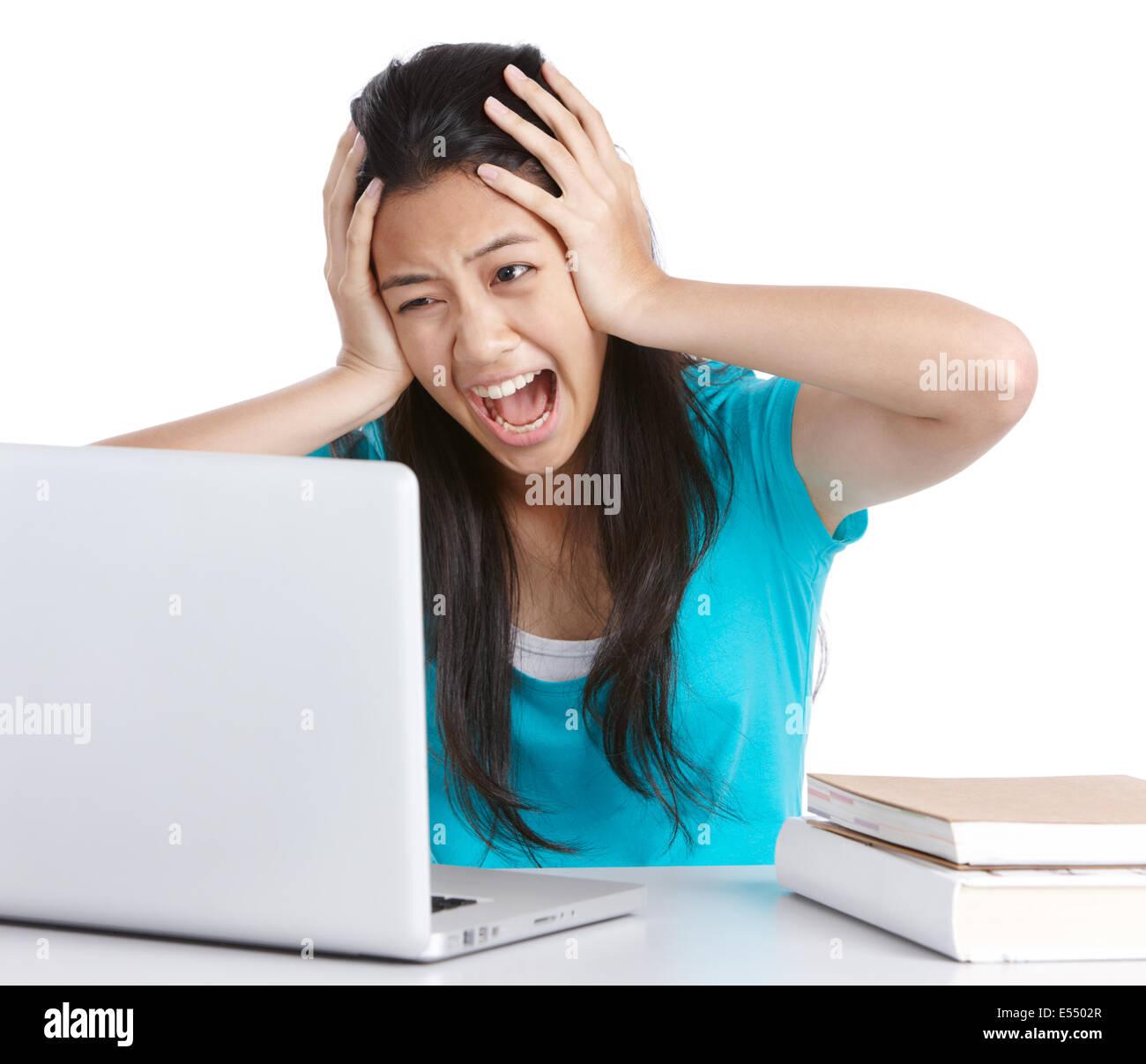 frustrated teenage girl with laptop and books Stock Photo - Alamy