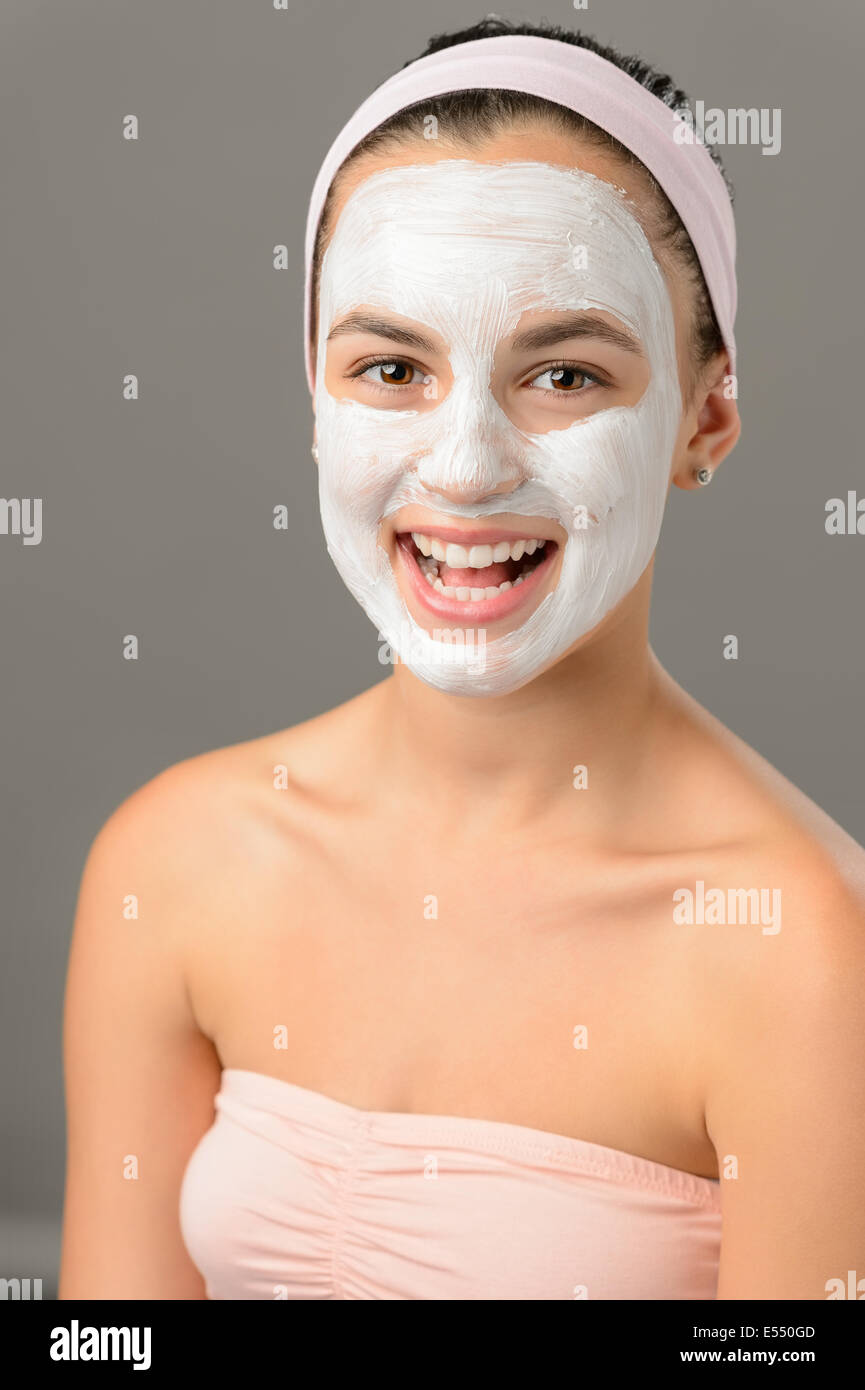 Body care young woman white facial mask smiling on gray background ...