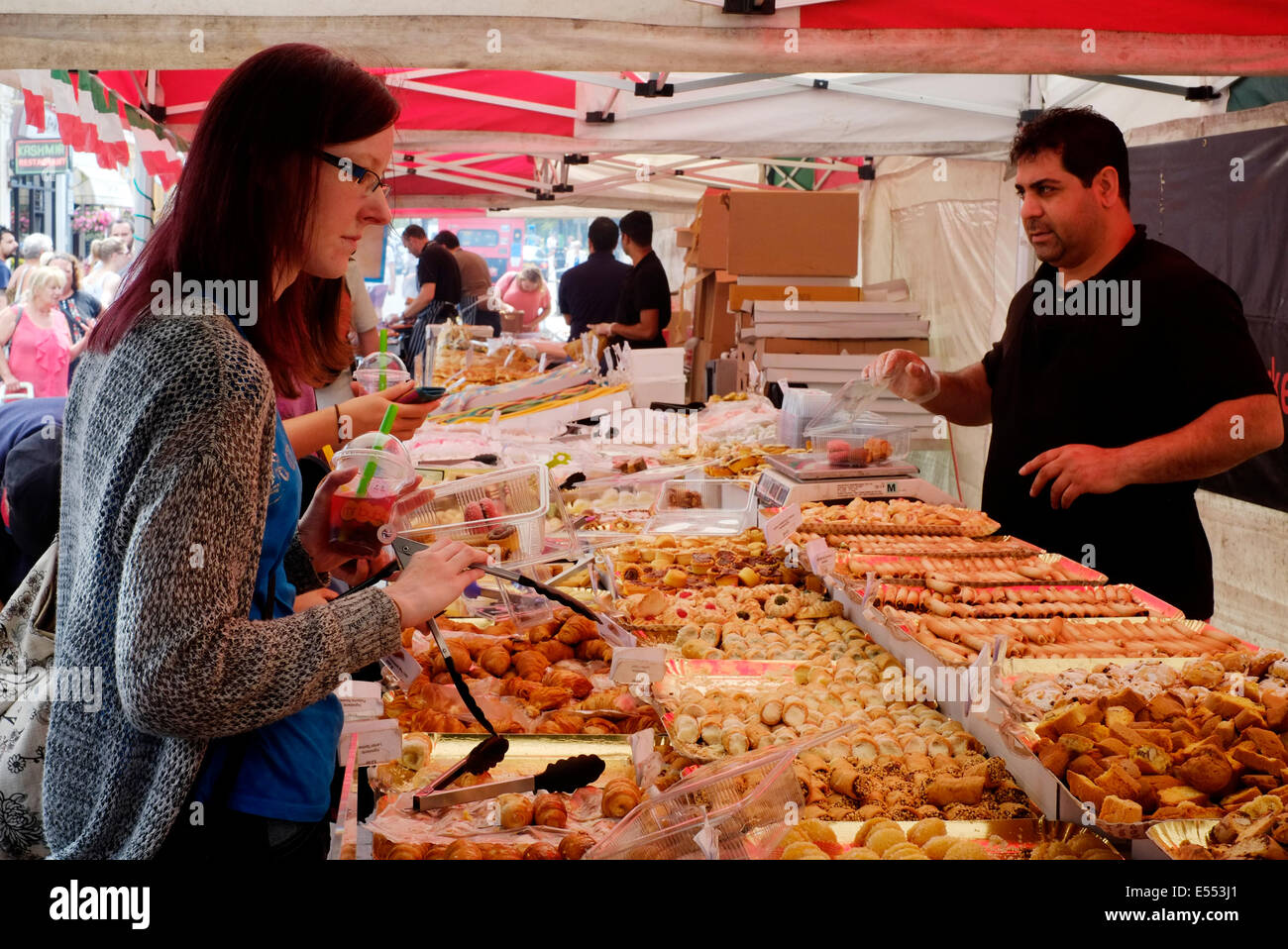 female customer choosing pastries and snacks at a stall at the southsea ...