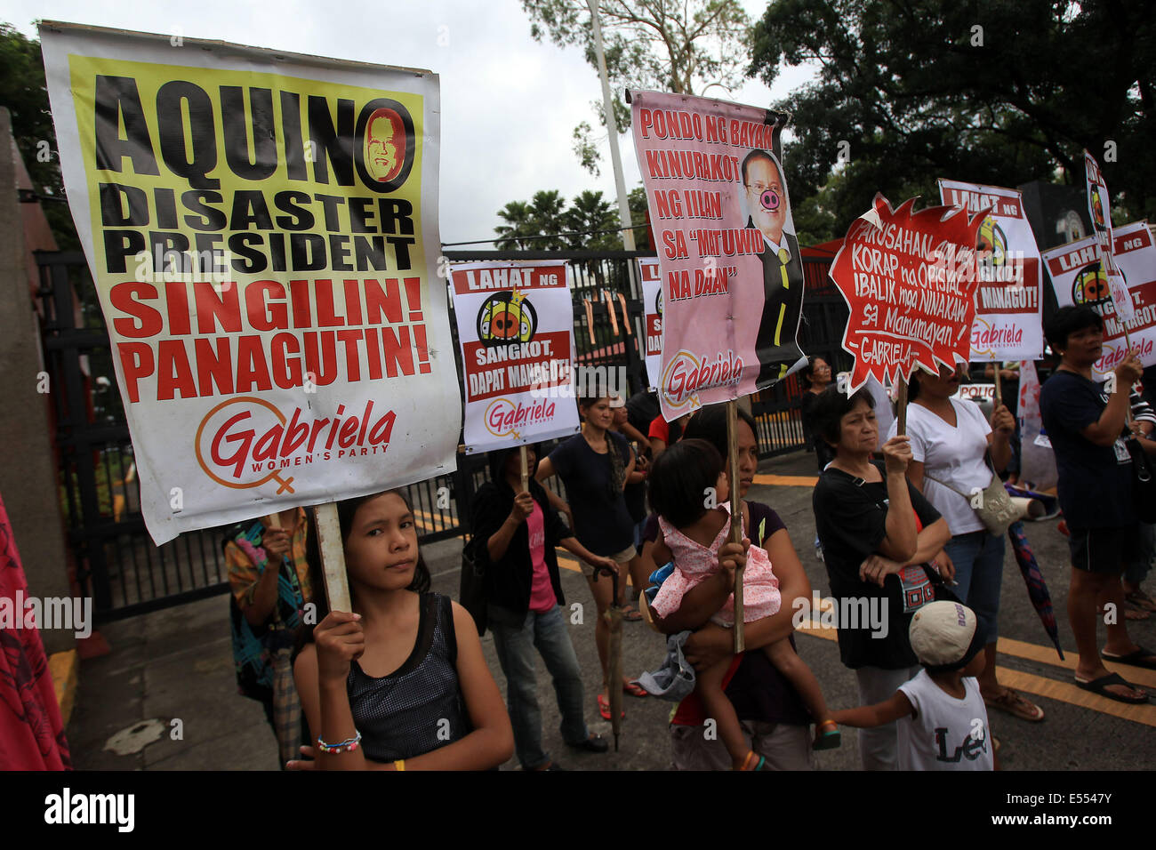 Quezon City, Philippines. 21st July, 2014. Activists display placards ...